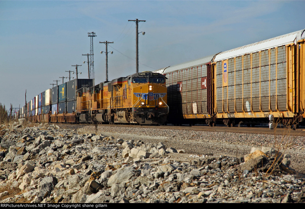 UP 7439 Heads out of town with a long stack in tow